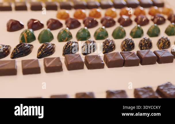 Vibrant row of colorful chocolate bonbons truffles on white pastry tray ...