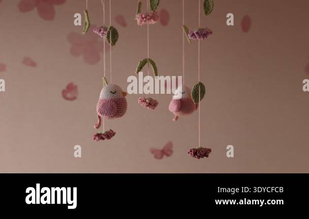 Spinning mobile in baby girl's bedroom with bird and flowers Stock ...