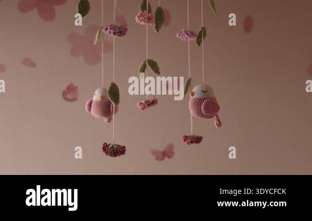 Spinning mobile in baby girl's bedroom with bird and flowers Stock ...