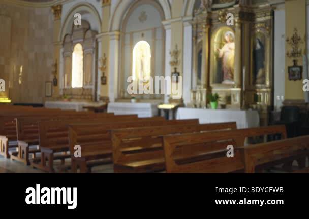 Blurred church interior with soft bokeh, defocused altar and wooden ...