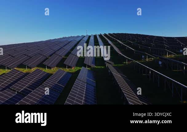 Solar panels are arranged on a hillside, collecting sunlight to ...