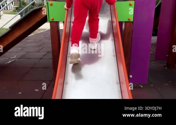 Child Girl Daughter Playing On Colored Playground rolls down children ...