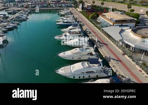 Drone capture of a harbor packed with boats, surrounded by coastal ...