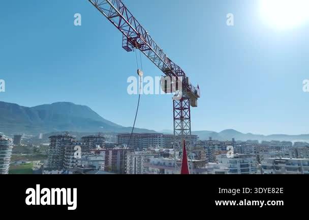 Drone captures crane lifting materials on site Stock Video Footage - Alamy