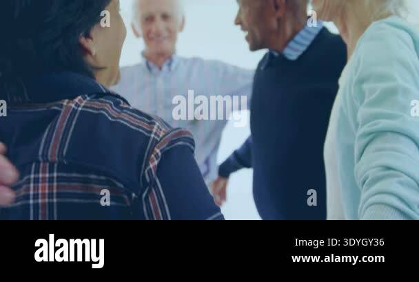 Therapy group with digital overlay hovering, extending arms inward and ...