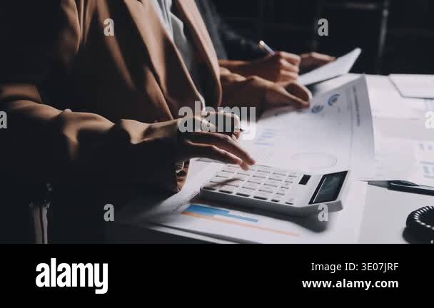 Two Businessman Calculating Bills Using Calculator At Workplace ...