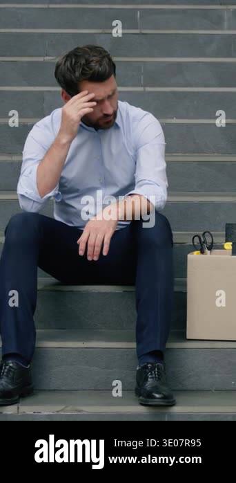 Fired sad Caucasian middle aged businessman sitting stairs with box in ...