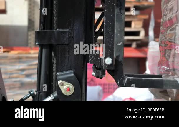 Forklift transporting pallet in warehouse logistics close up tracking ...