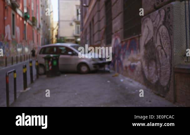 Ghetto alley with graffiti covered walls and parked car rendered in ...