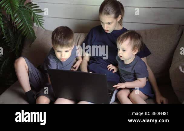 Young sibling assisting with laptop. Children exploring computer usage ...