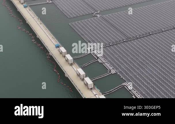 Aerial view of a large floating solar panel farm on a reservoir, an ...