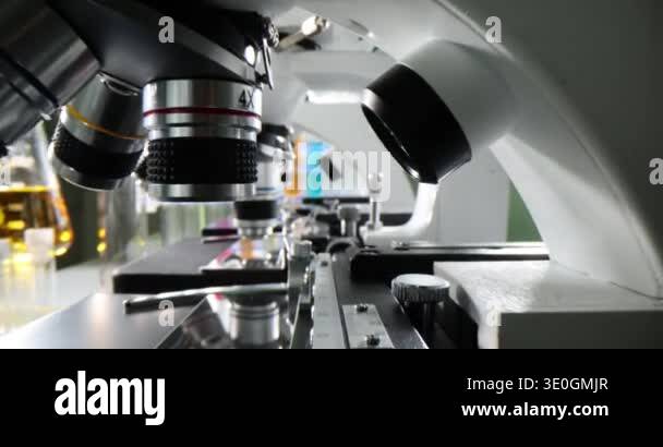 Many microscopes and glass test tubes in chemical laboratory closeup 4k ...