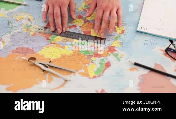 Geologist with ruler on world map. Student cartographer measures ...