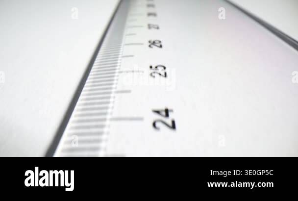 White plastic transparent ruler on white sheet. Length measurements ...