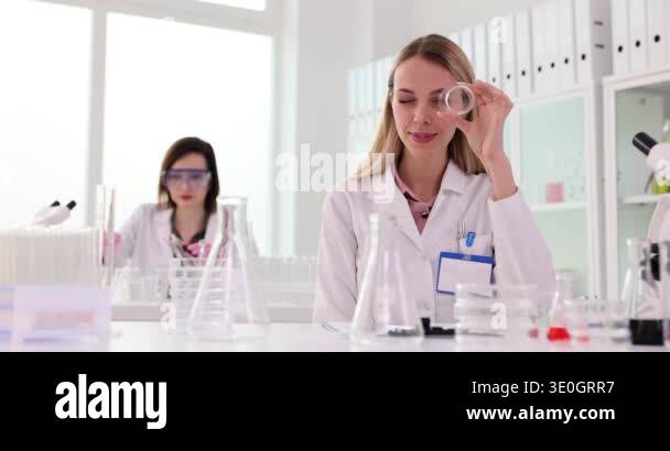 Pretty young biology student in science laboratory smiling through ...