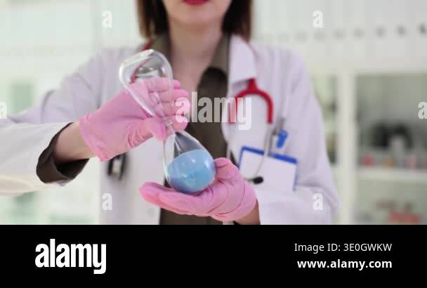 Doctor holds hourglass timer symbolizing importance of time management ...