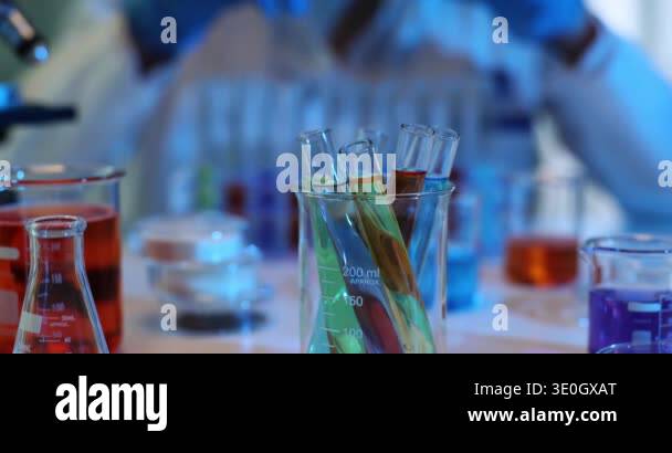 Chemical laboratory experiment with colorful liquids in glass ...