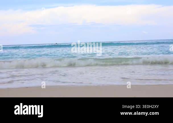 Calm tropical shoreline view, idyllic beachscape with soothing waves ...