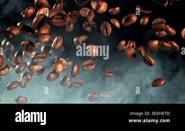 Super slow motion Coffee beans with smoke . Filmed on a high-speed ...
