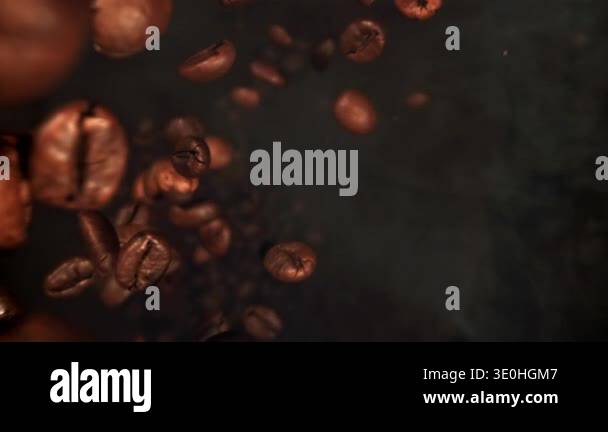Super slow motion Coffee beans with smoke . Filmed on a high-speed ...