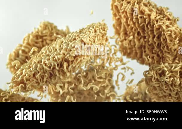 Instant noodles fly on a light background. Filmed on a high-speed ...