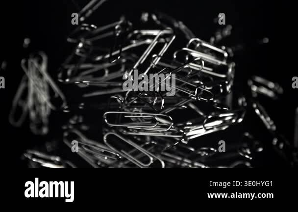 Paper clips fly and fall. Filmed on a high-speed camera at 1000 fps ...
