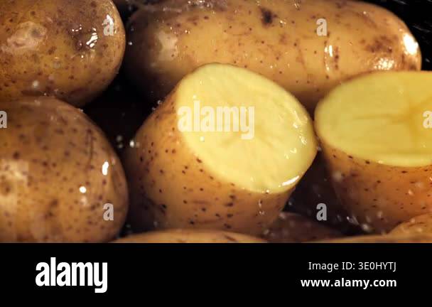 Water droplets fall on the potatoes. Filmed on a high-speed camera at ...