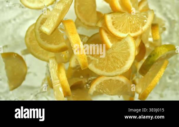 Lemon slices fly on a light background. Filmed on a high-speed camera ...