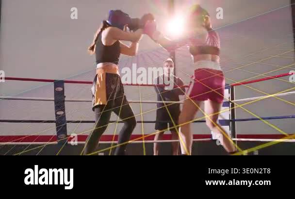 Female boxers sparring in boxing, pink-gloved boxer pressing to score ...