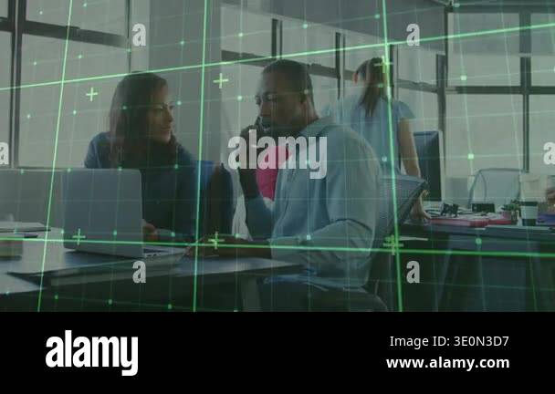 Man taking incoming call while typing with office woman, faint green ...