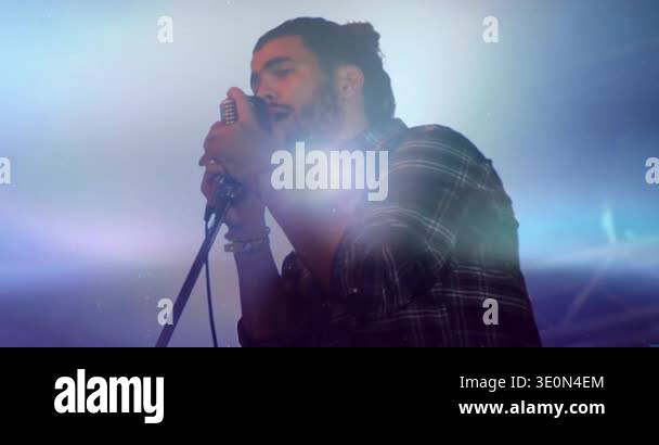Male vocalist holding retro mic while singing music, blue-purple lights ...