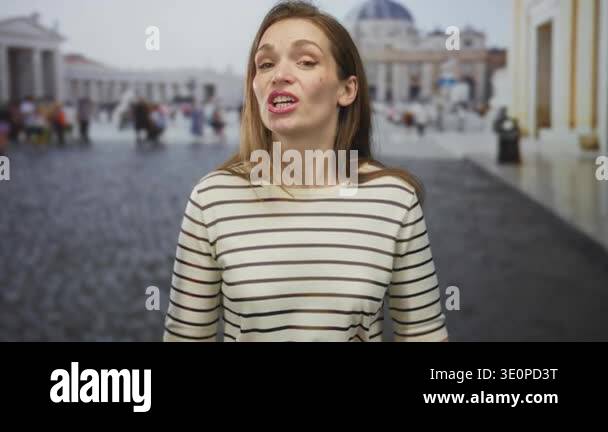 Young caucasian woman talking with open mouth in street outside the ...