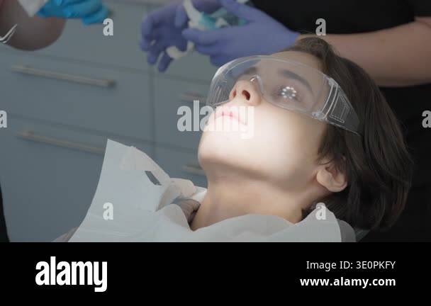 Doctor performing surgical removal of deciduous tooth using ...