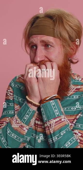 Upset scared frightened hippie redhead bearded man biting nails ...