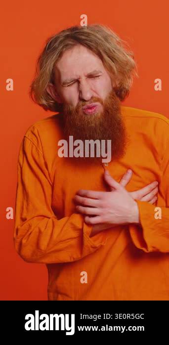 Stressed scared sick ill Caucasian man suffers from tension holding ...
