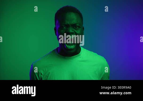 Portrait of Black Man Looking at Camera and Screaming in Neon Colored ...
