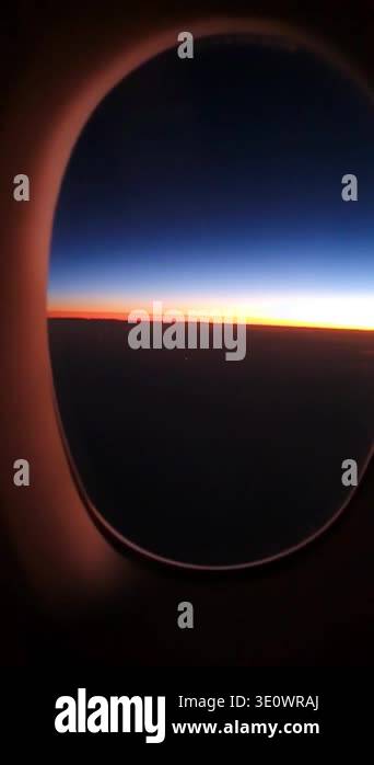 Sunrise horizon viewed from airplane window during flight. Colorful sky ...