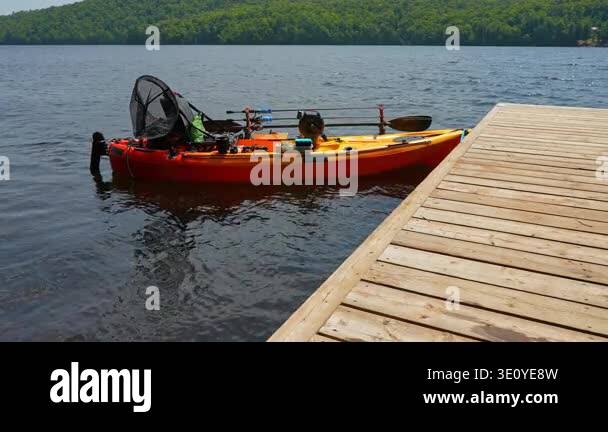 Fully rigged kayak watercraft mooring and tied to boat pier near ...