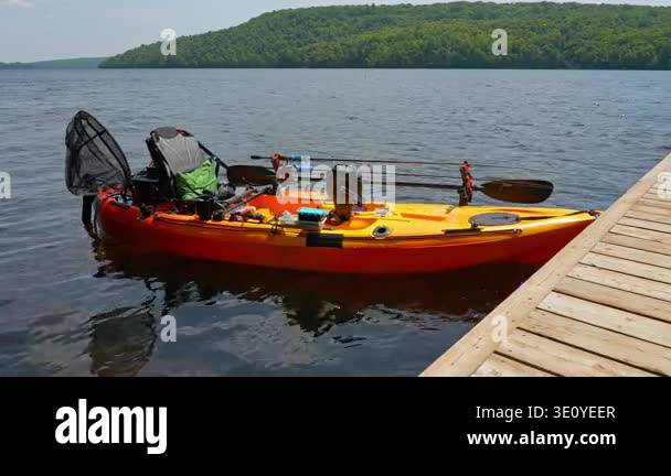 Fully rigged kayak watercraft mooring and tied to boat pier near ...