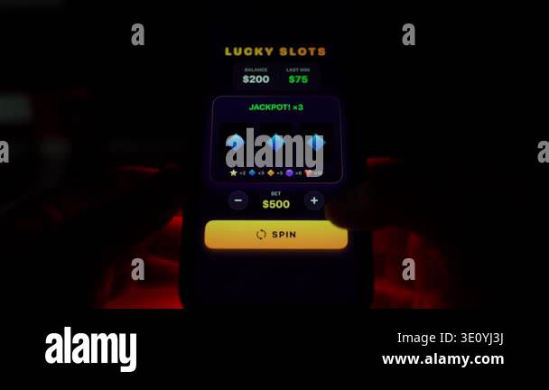 Player playing slots on mobile app in dark room with colorful backlight ...