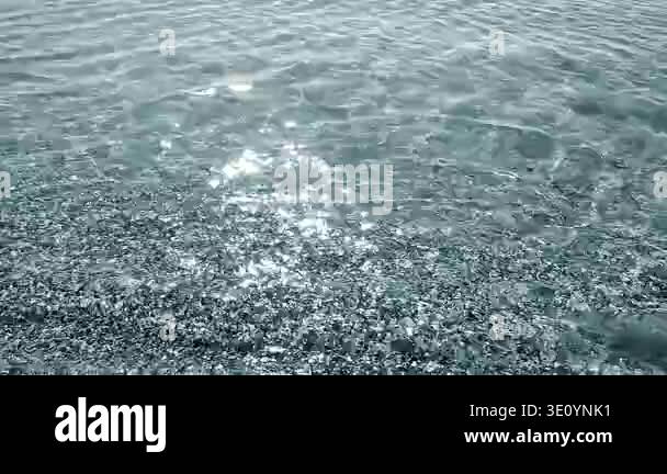 Transparent clean water on shallow sandy seashore with shells with ...
