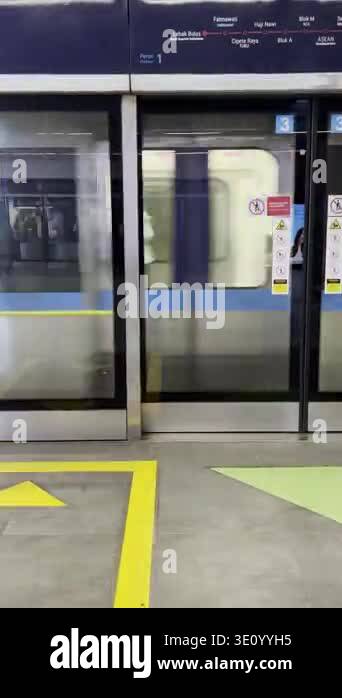 Vertical video of a Jakarta MRT train departing from an underground ...