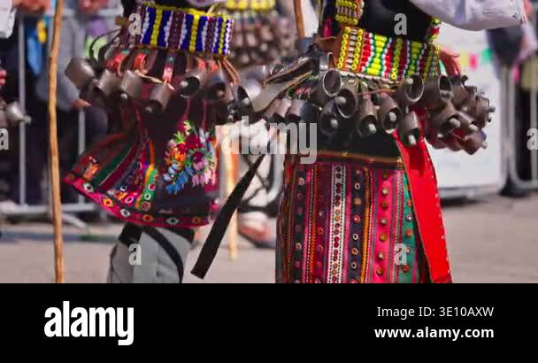 Bulgarian Kukers with bells and traditional costumes, masked people ...