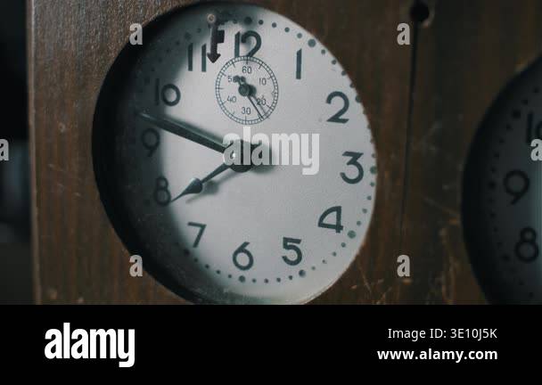 Close up of a vintage wooden analog clock face with hands moving ...