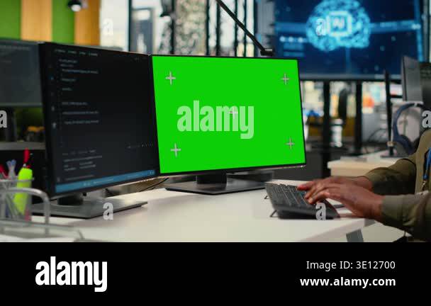 Green screen computer used by admin in office doing software ...