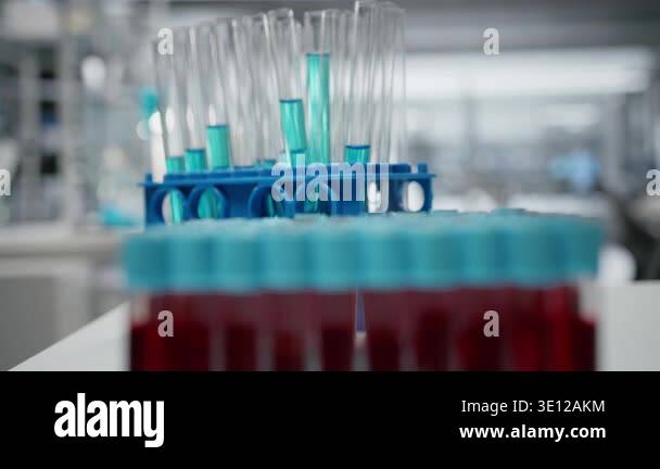 Close up of small glass flasks containing red blood samples on ...