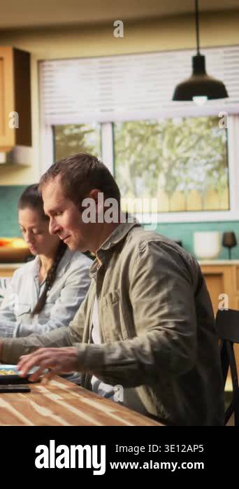 Vertical Video Drained weary working dad typing on laptop during ...