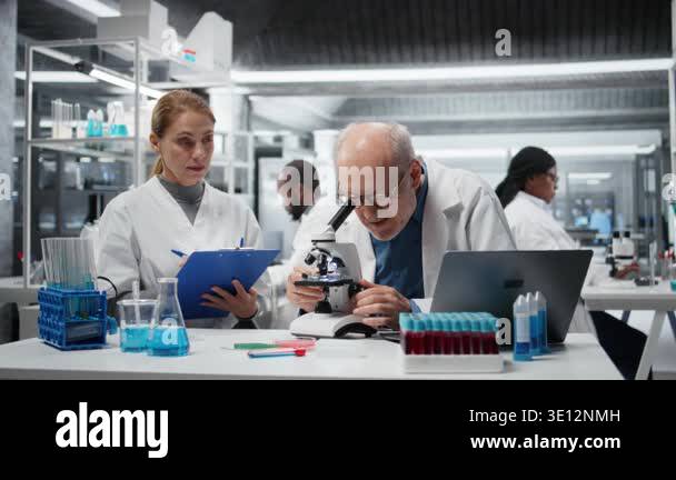 Team of cytotechnologist analyzing bacterial culture slide to test ...