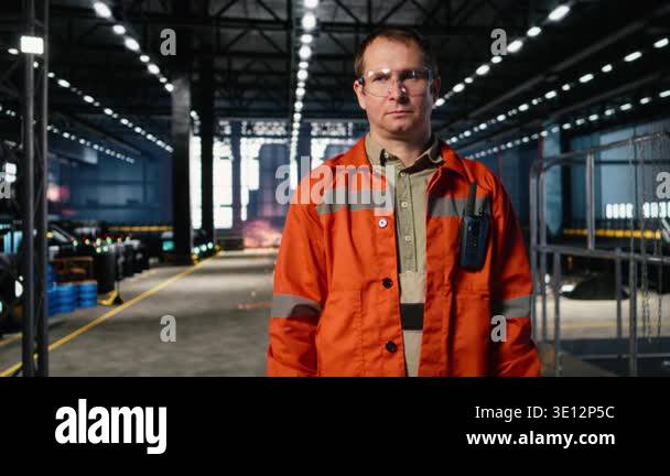 Professional employee in a warehouse uses equipment to guide operator ...