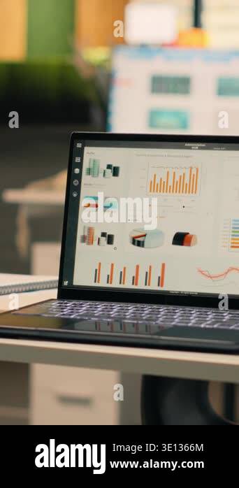 Vertical Video Company data reports running on laptop in empty business ...